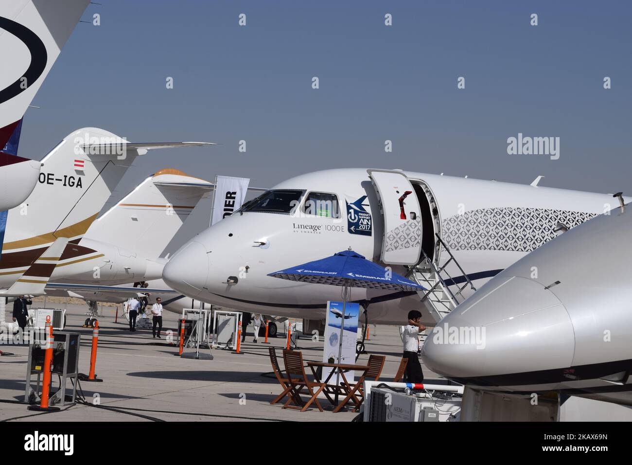 An Embraer lineage 1000 private jet with an open door and red carpet at ...