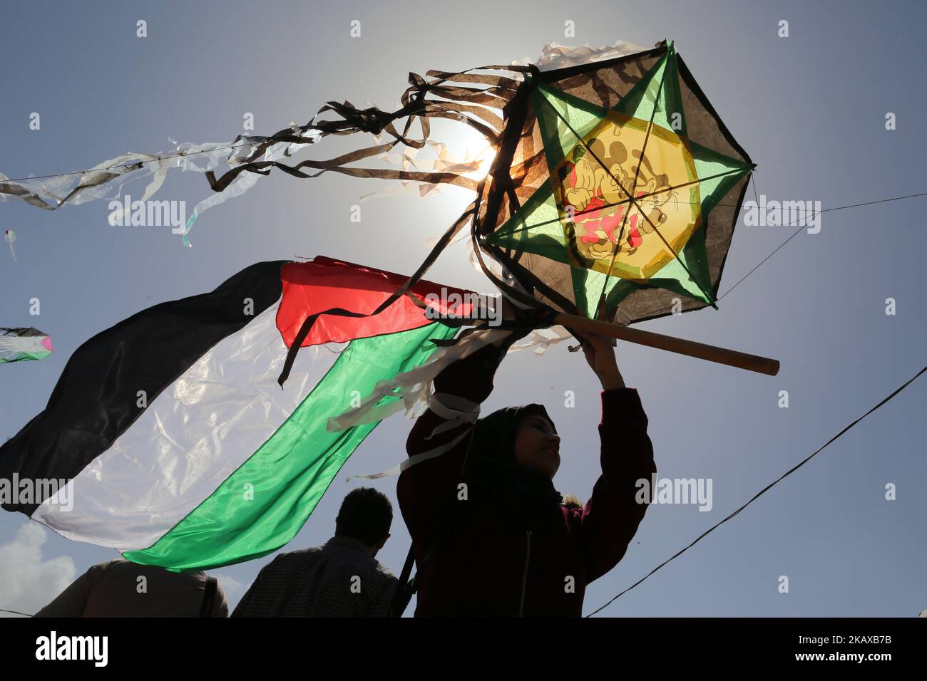 A Palestinian woman flies a kite during a demonstration ahead of the ...