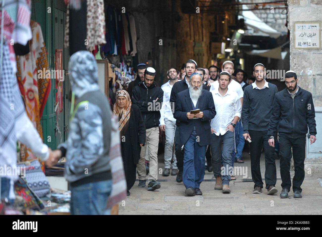 A group of Jews walk trough the Muslim Quarter inside the Old City in ...