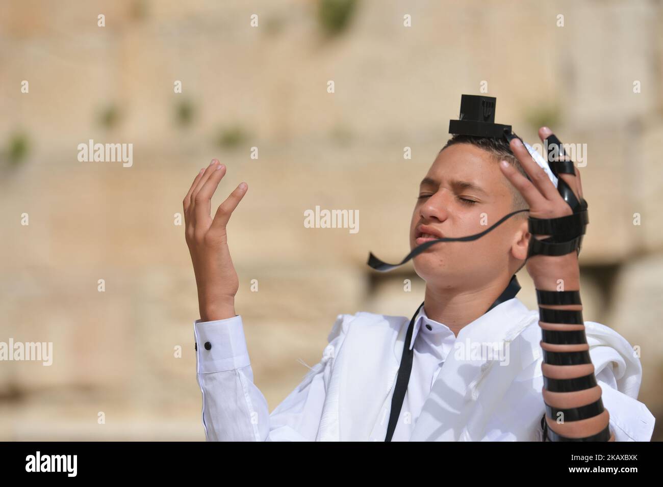 Bar mitzvah boy wearing tallit and tefillin at The Western Wall in the ...