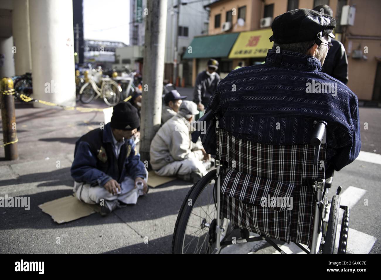 OSAKA, JAPAN - MARCH 31: Homeless men talk to each other along a street ...