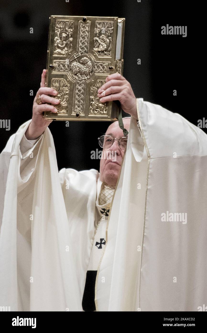 Pope Francis holds Holy Bible during he has presides over a solemn ...