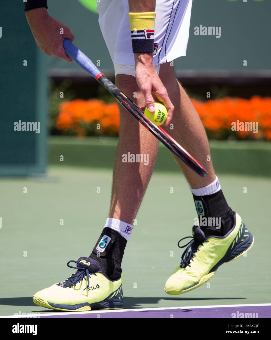 John Isner, from the USA, in action against Juan Martin Del Potro, from ...