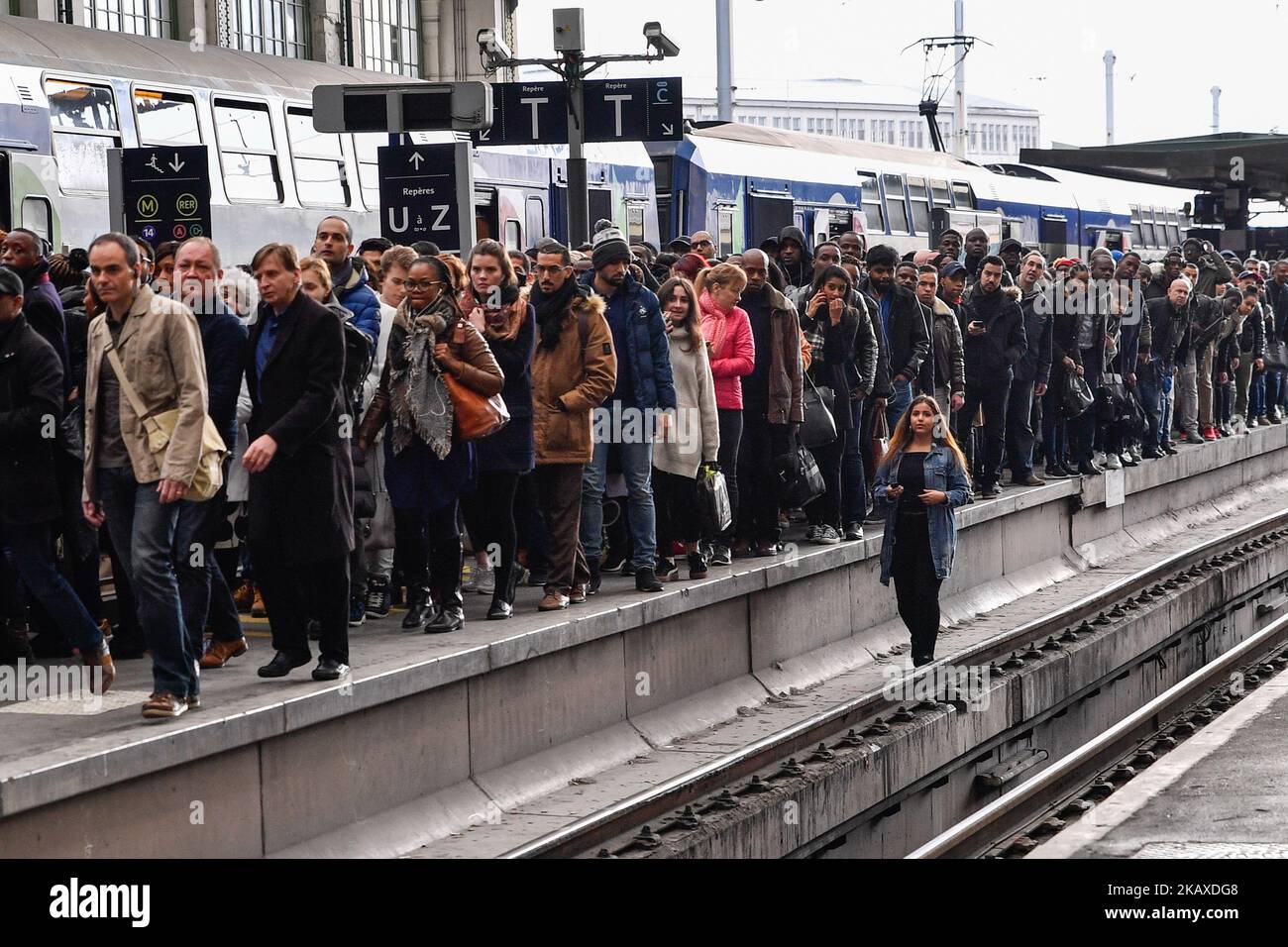 Commuters stand on a crowded platform of the Gare de Lyon railway ...