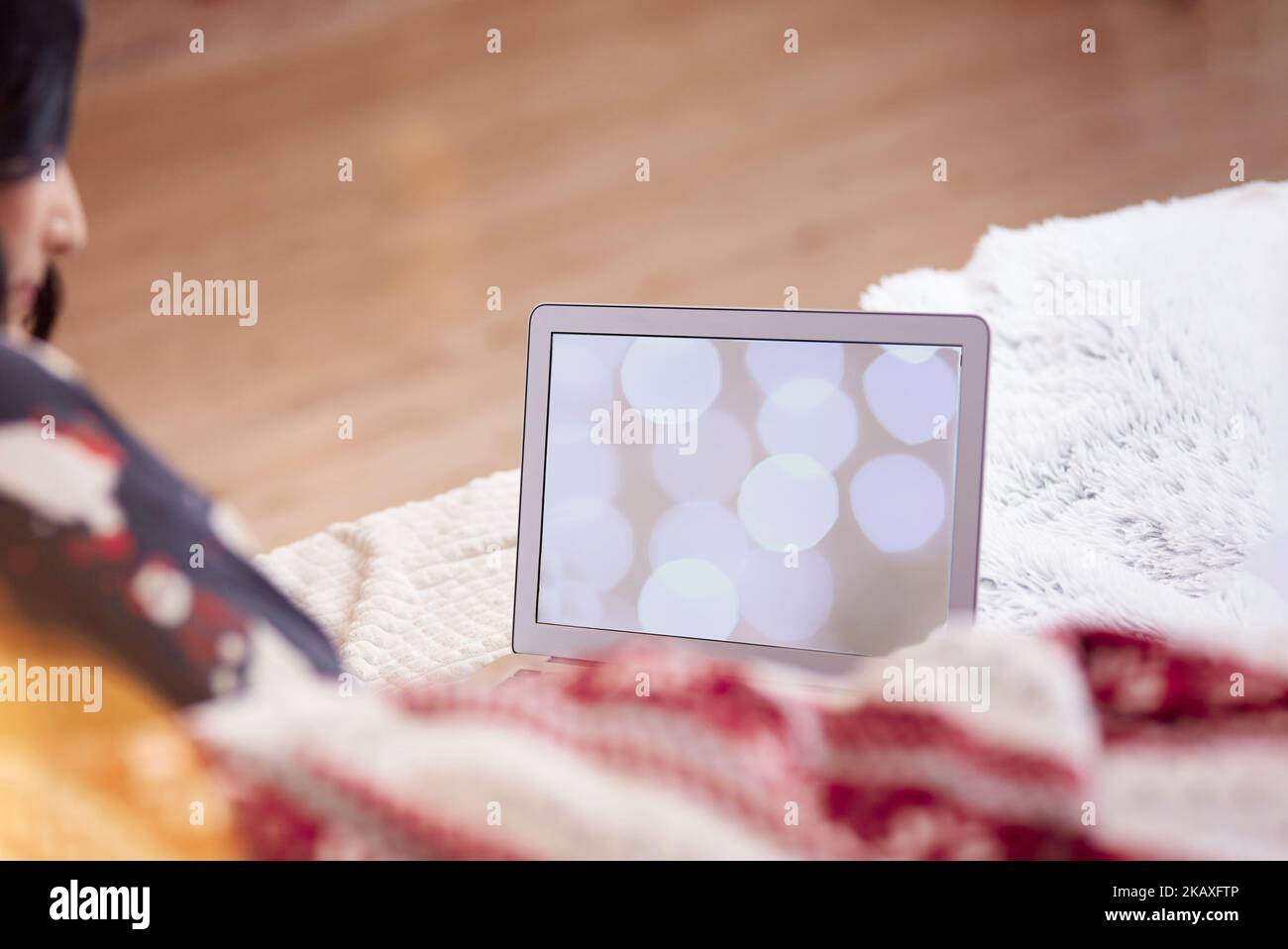 Woman is typing on laptop keyboard. Bokeh screen of notebook close up ...