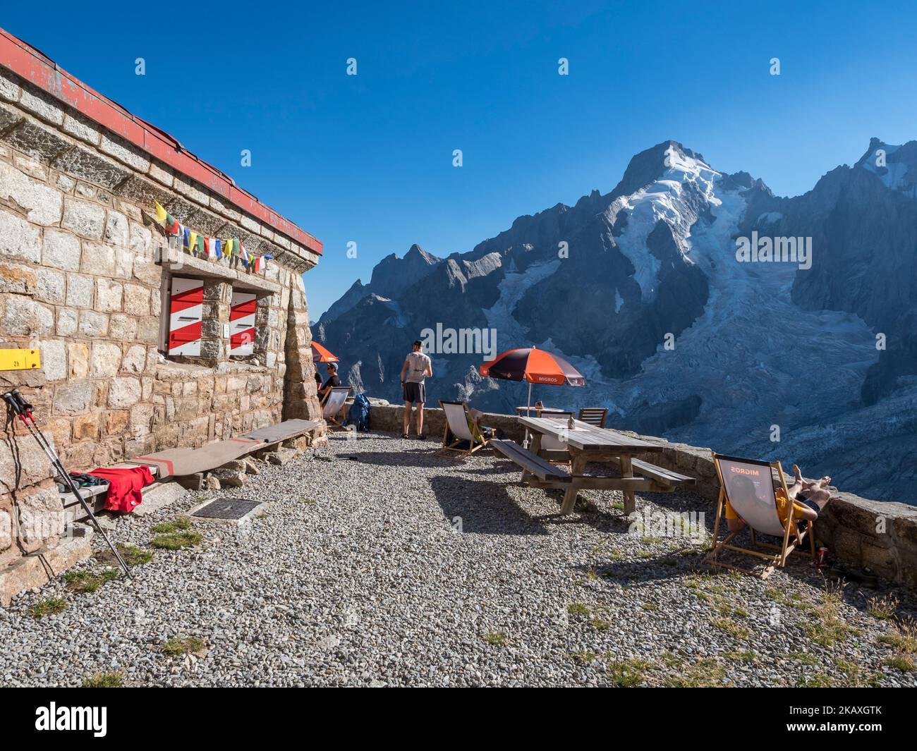 Refuge Cabane de l'A Neuve, tourists sitting on terrace, Aiguille ...