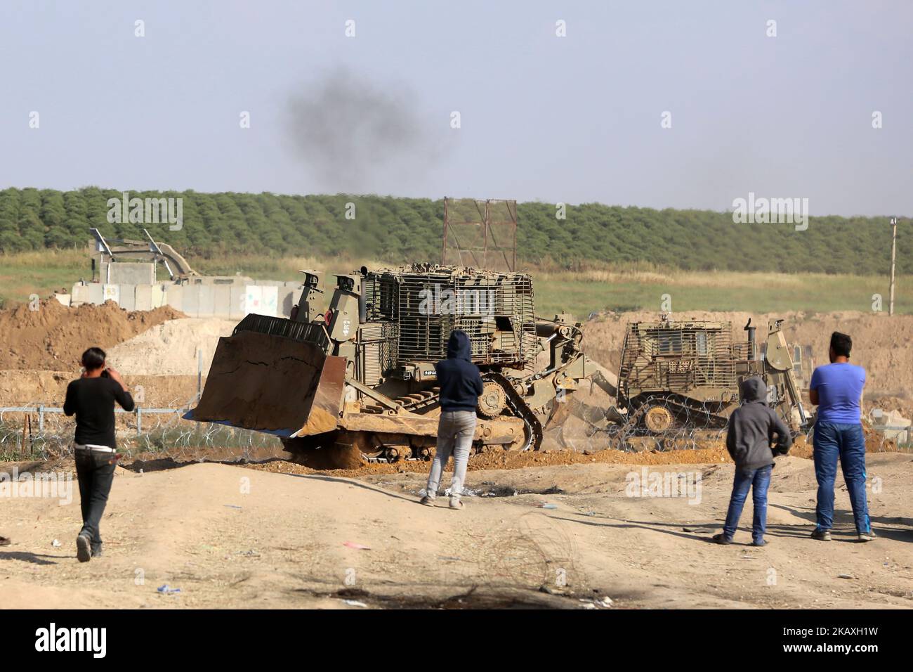 Israeli bulldozers and the soldiers work at the Israel-Gaza border ...