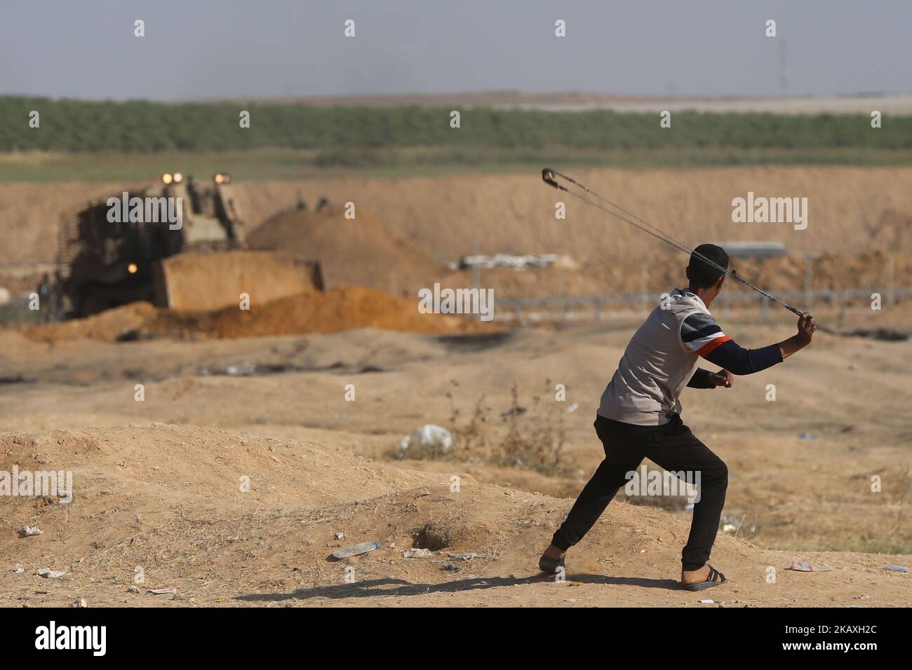 Israeli bulldozers and the soldiers work at the Israel-Gaza border ...