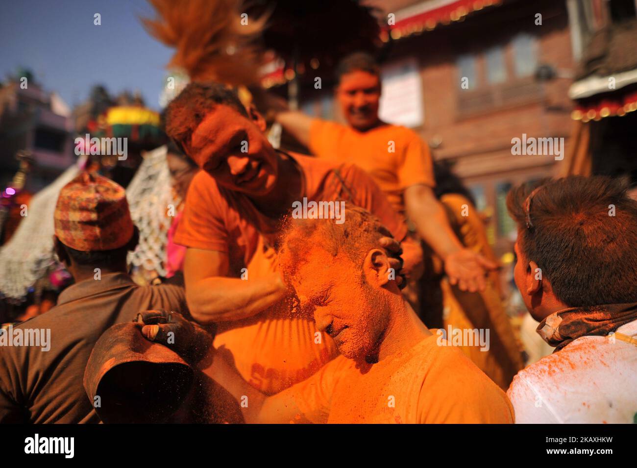 Nepalese devotee applying vermillion powder towards his friends during ...