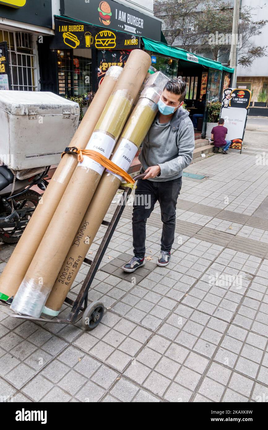 Using pushing dolly cart delivering large cardboard tubes hi-res stock ...
