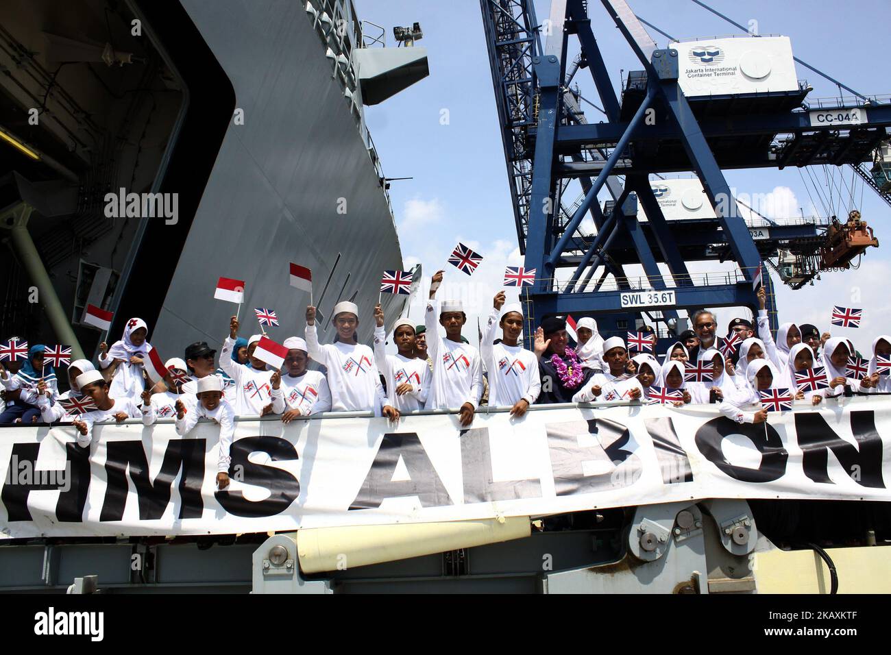 Commander Officer HMS Albion, Captain Tim Neild, stand with childrens ...