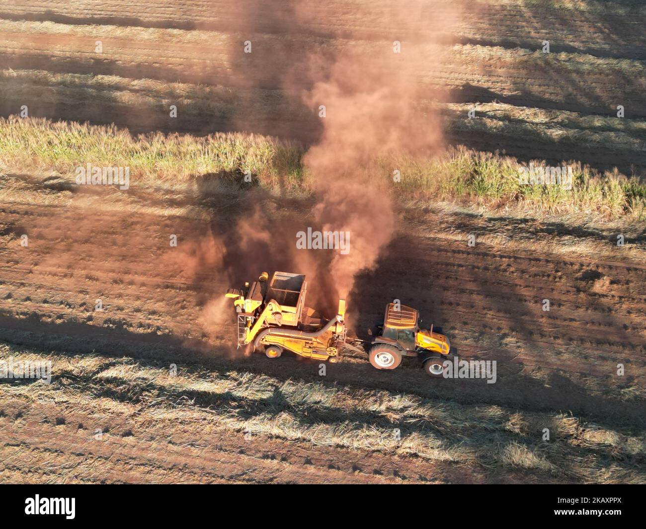 An aerial of a manure spreader machine riding through the field in ...