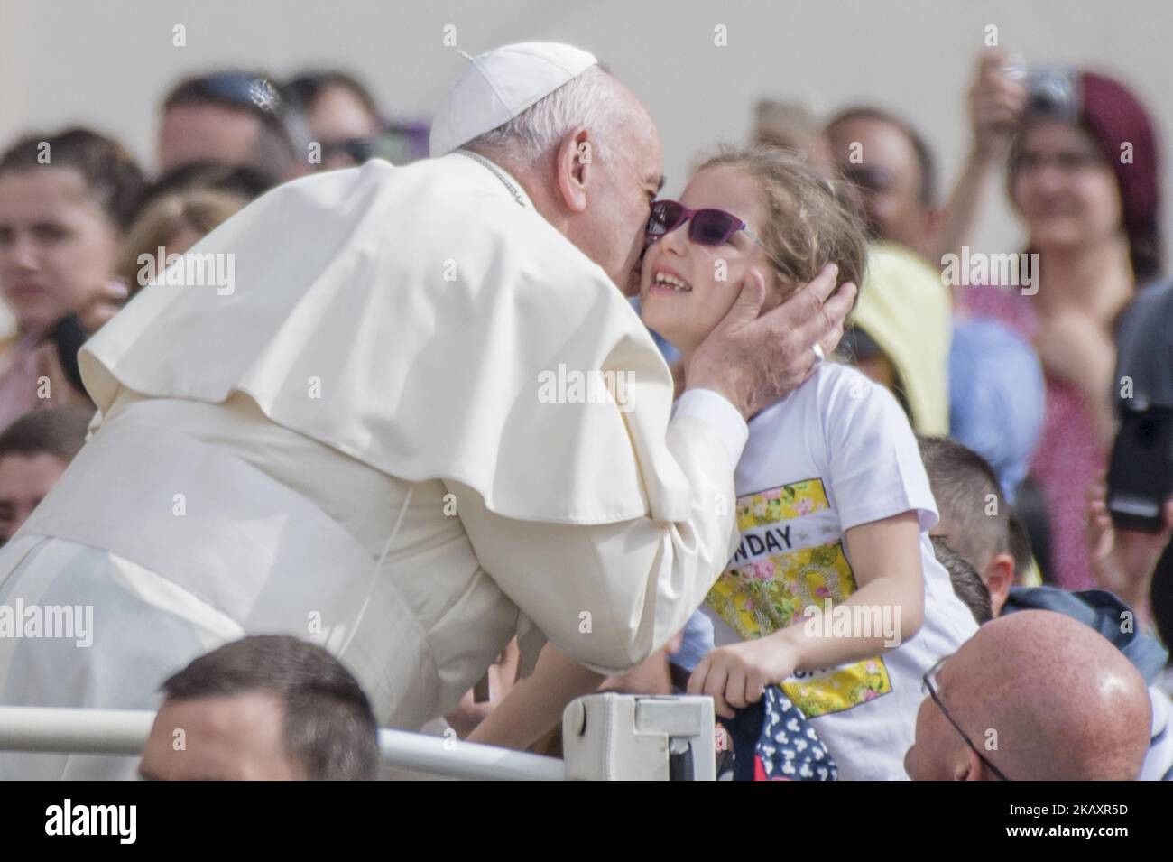 Pope Francis kisses a child during his weekly general audience, in St ...