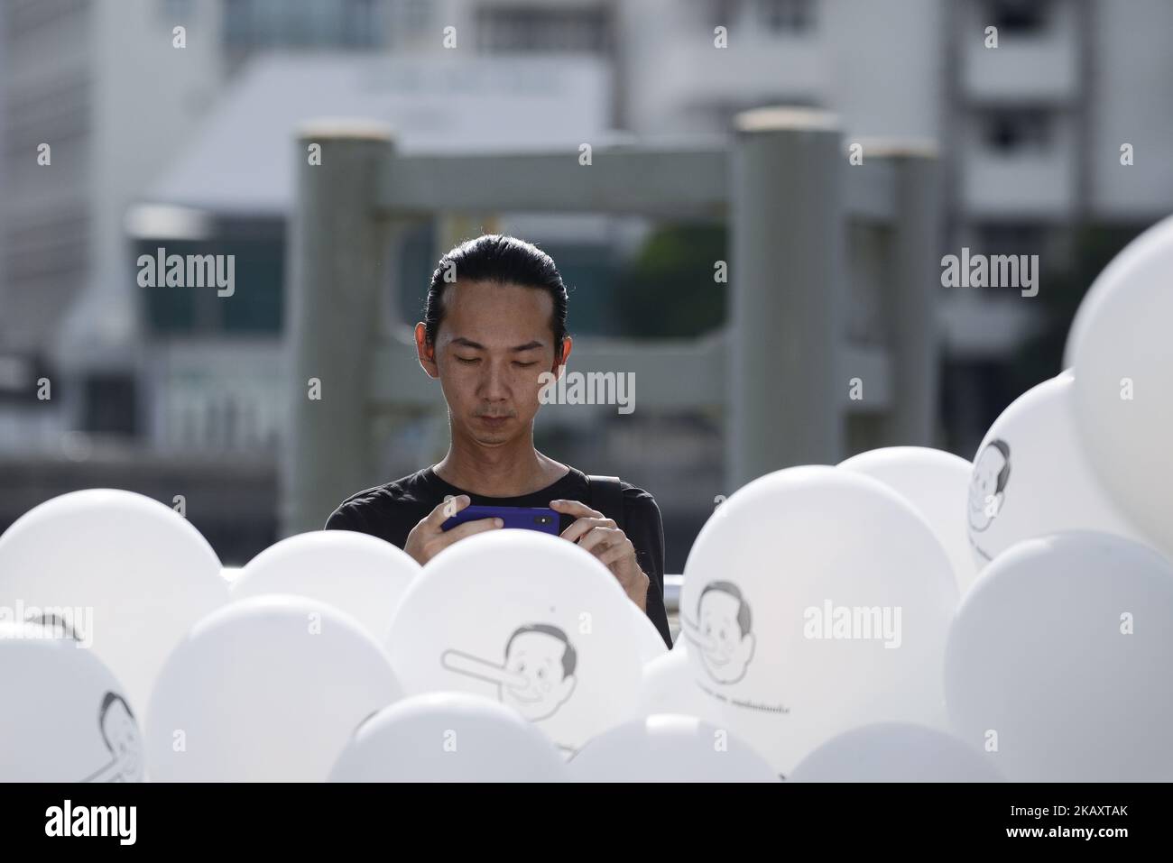 Pro-democracy activists set up balloons with a cartoon depicting Thai ...