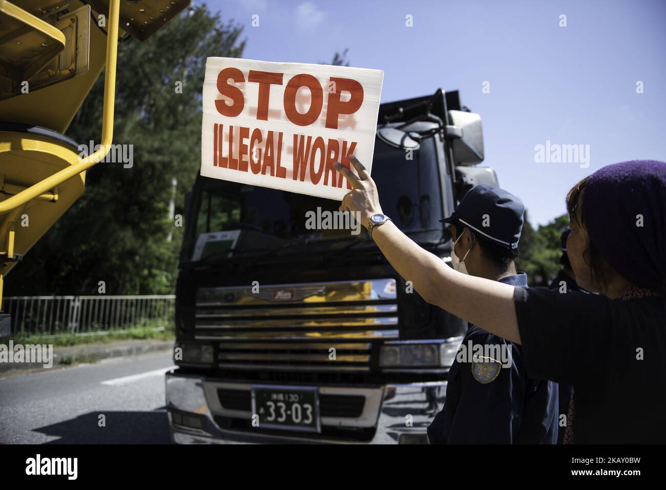 Protesters with placards block construction vehicles from entering the ...