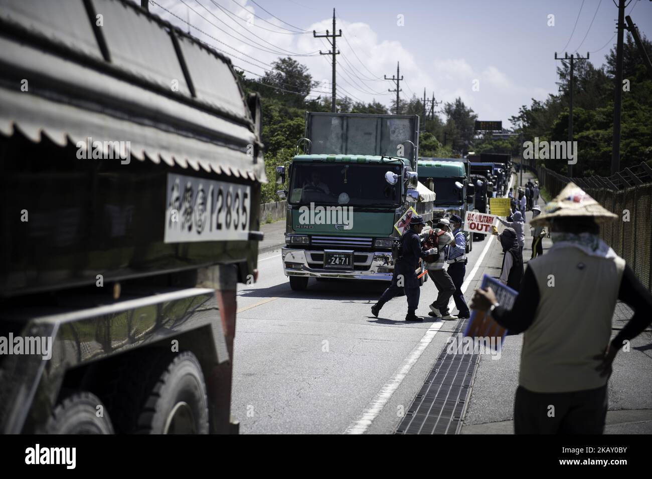 Protesters with placards block construction vehicles from entering the ...