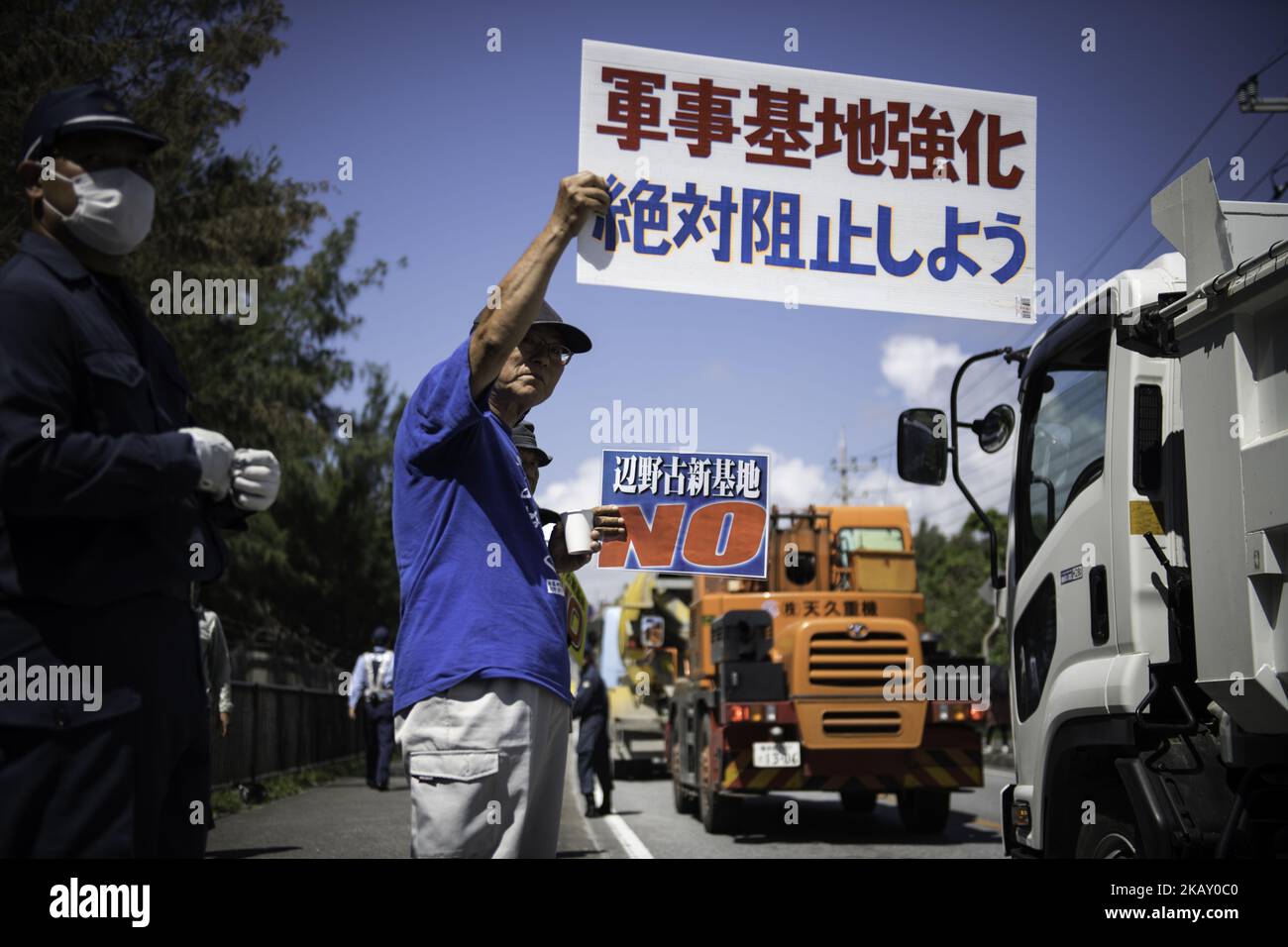 Protesters with placards block construction vehicles from entering the ...