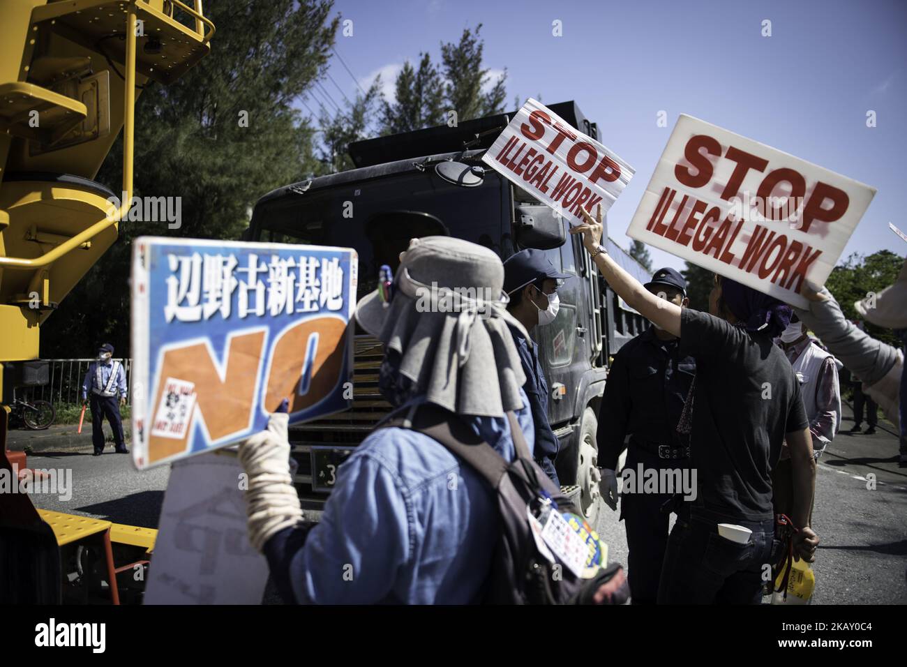 Protesters with placards block construction vehicles from entering the ...