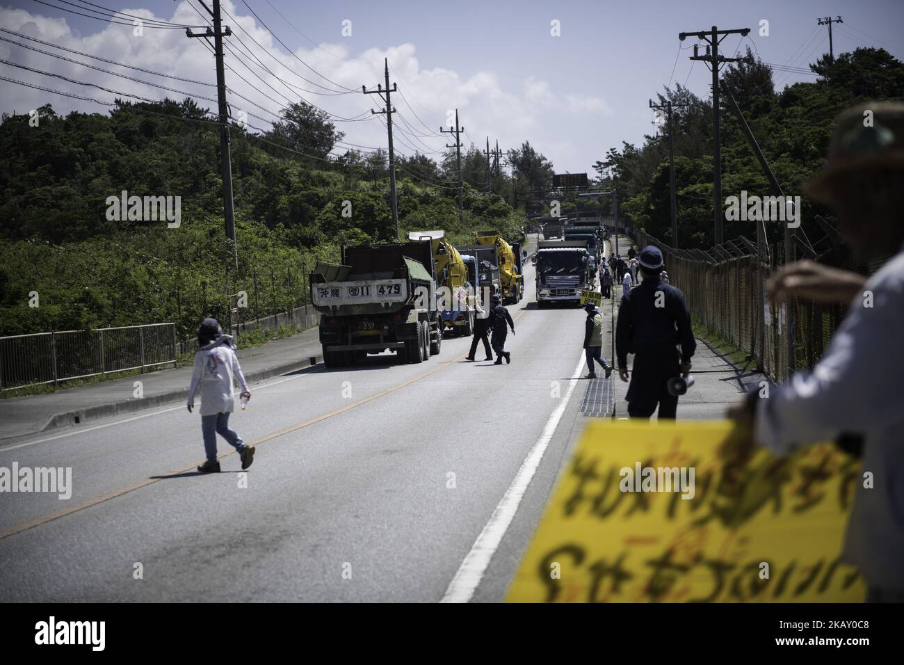 Protesters with placards block construction vehicles from entering the ...