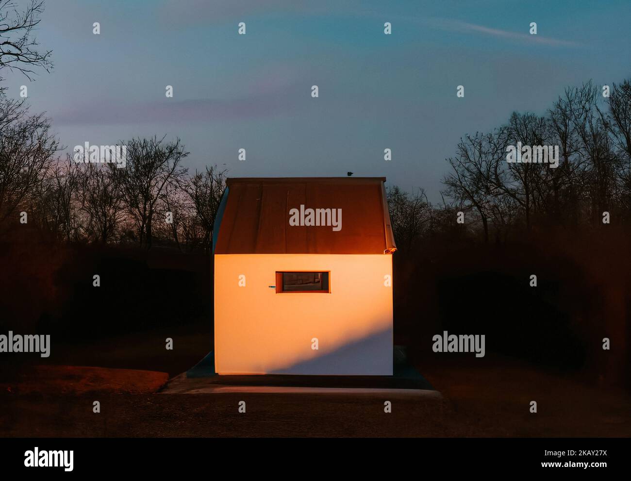 A 3D render of a simple small house design in a park at sunset Stock ...