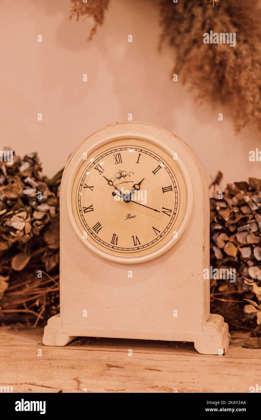 Mechanical clock with an alarm clock on the table in the interior. Loft ...