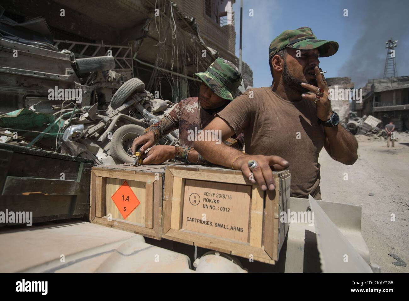 (7/11/2017) Two soldiers open ammunition boxes at the front in Mosul ...