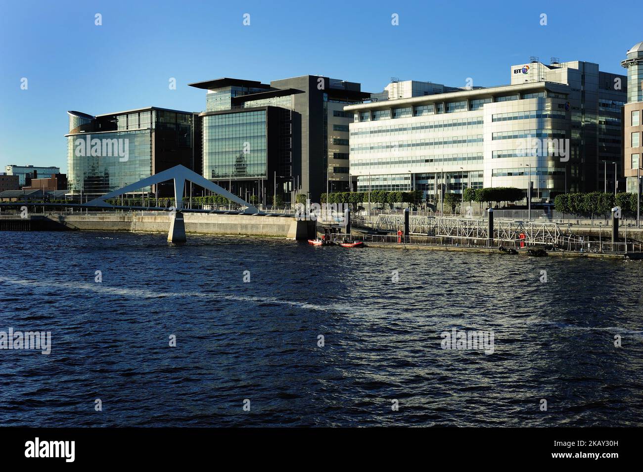 A scenic view of Clyde river with modern shoreline buildings under the ...