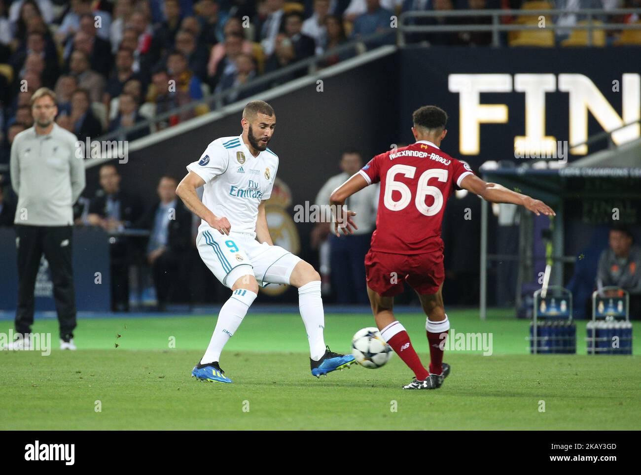 Real's forward Karim Benzema (L) vies for a ball with Liverpool's ...