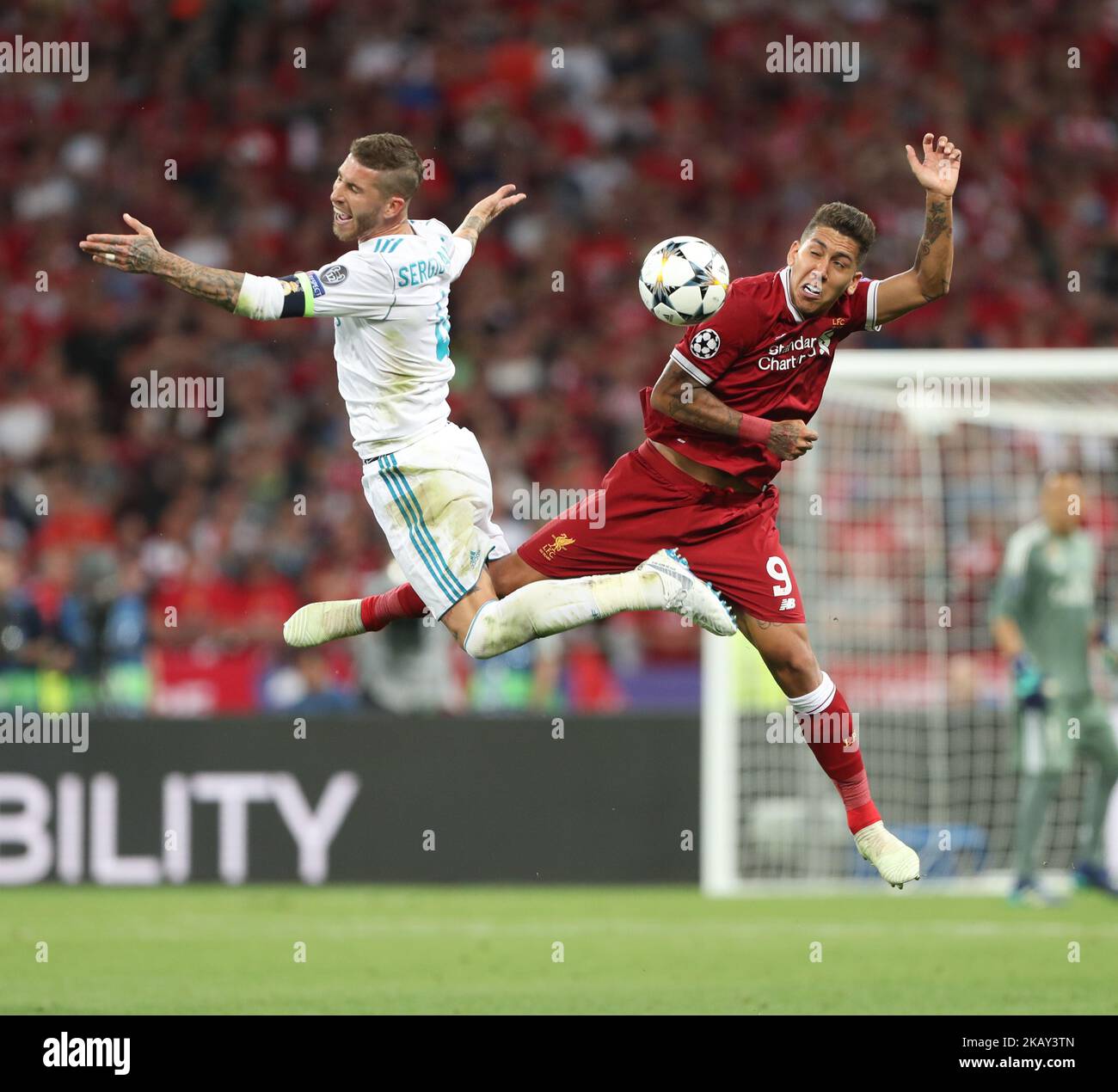 Liverpool's Brazilian forward Roberto Firmino (R) jumps for the ball ...