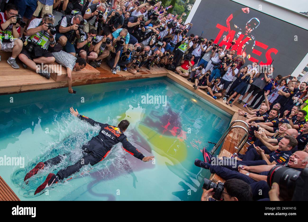 Daniel Ricciardo of Australia jumps into the pool at Red Bull energy ...
