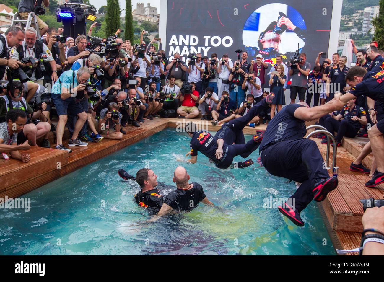 Red Bull team members jump into the pool at Red Bull energy station ...