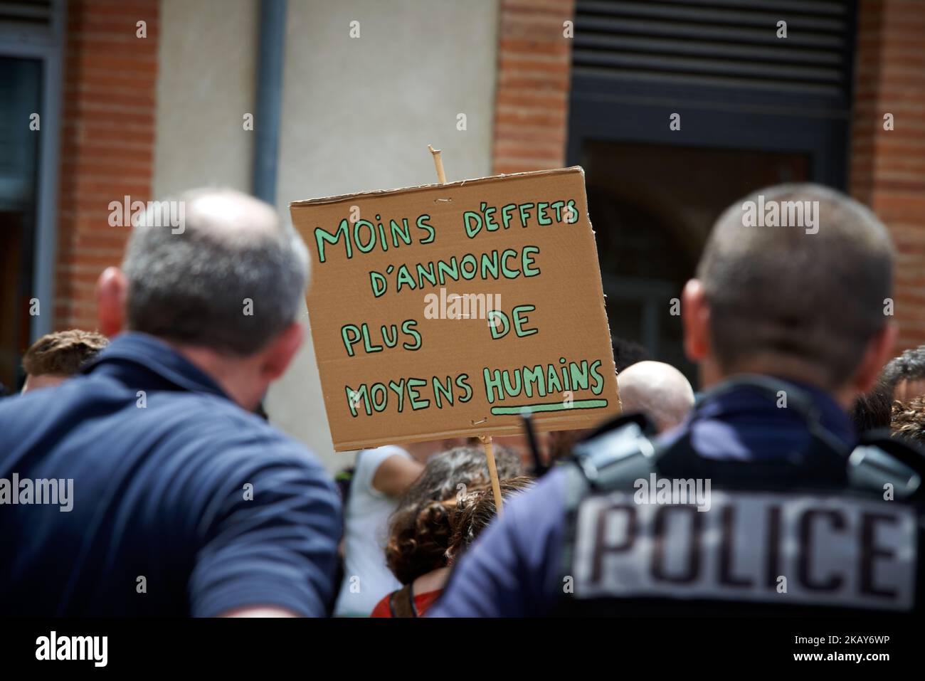 A teacher shows a placard reading 'Less announcement effects, more ...