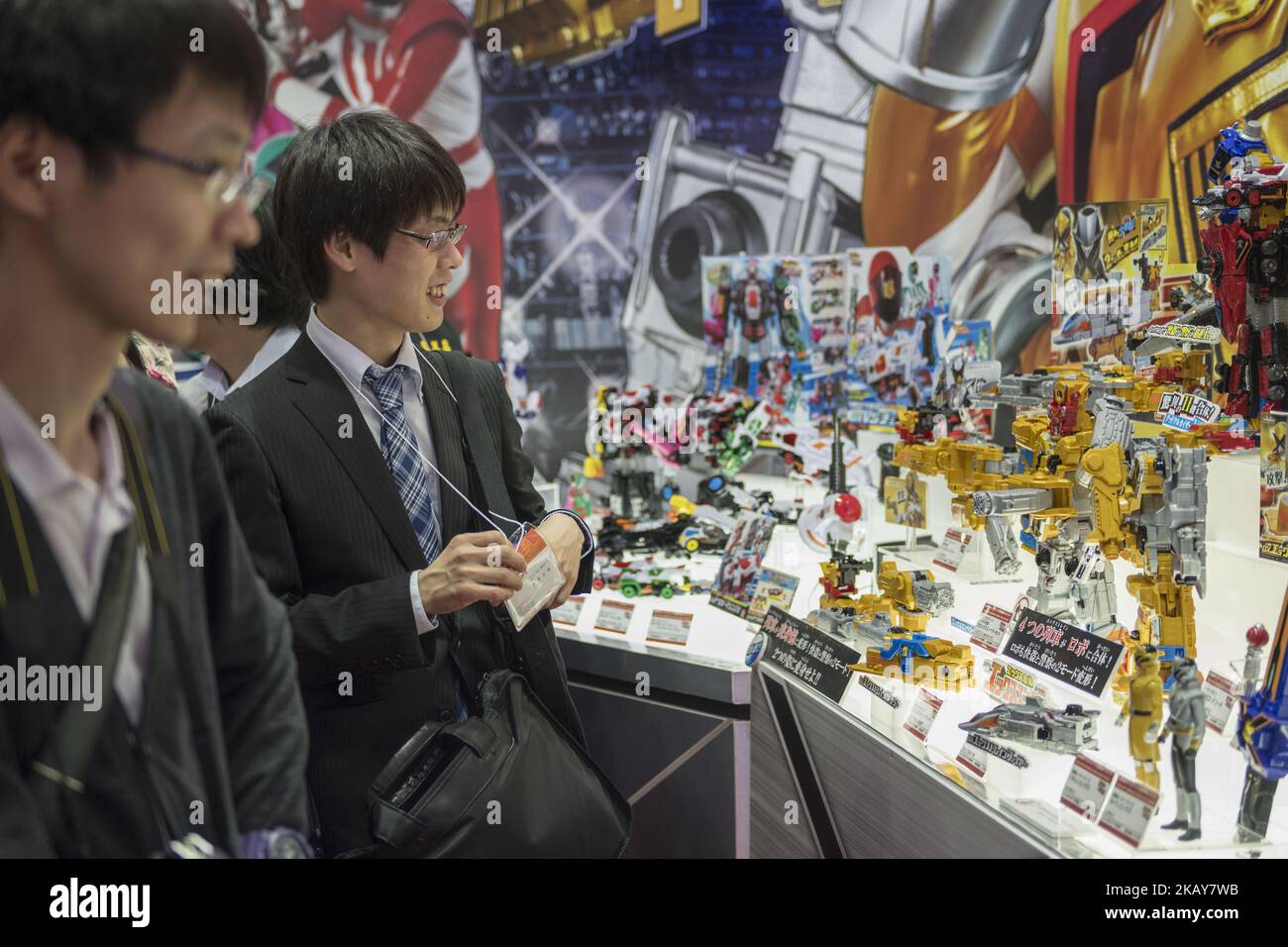 Visitors look at various plastic models Robot on display at the Bandai ...