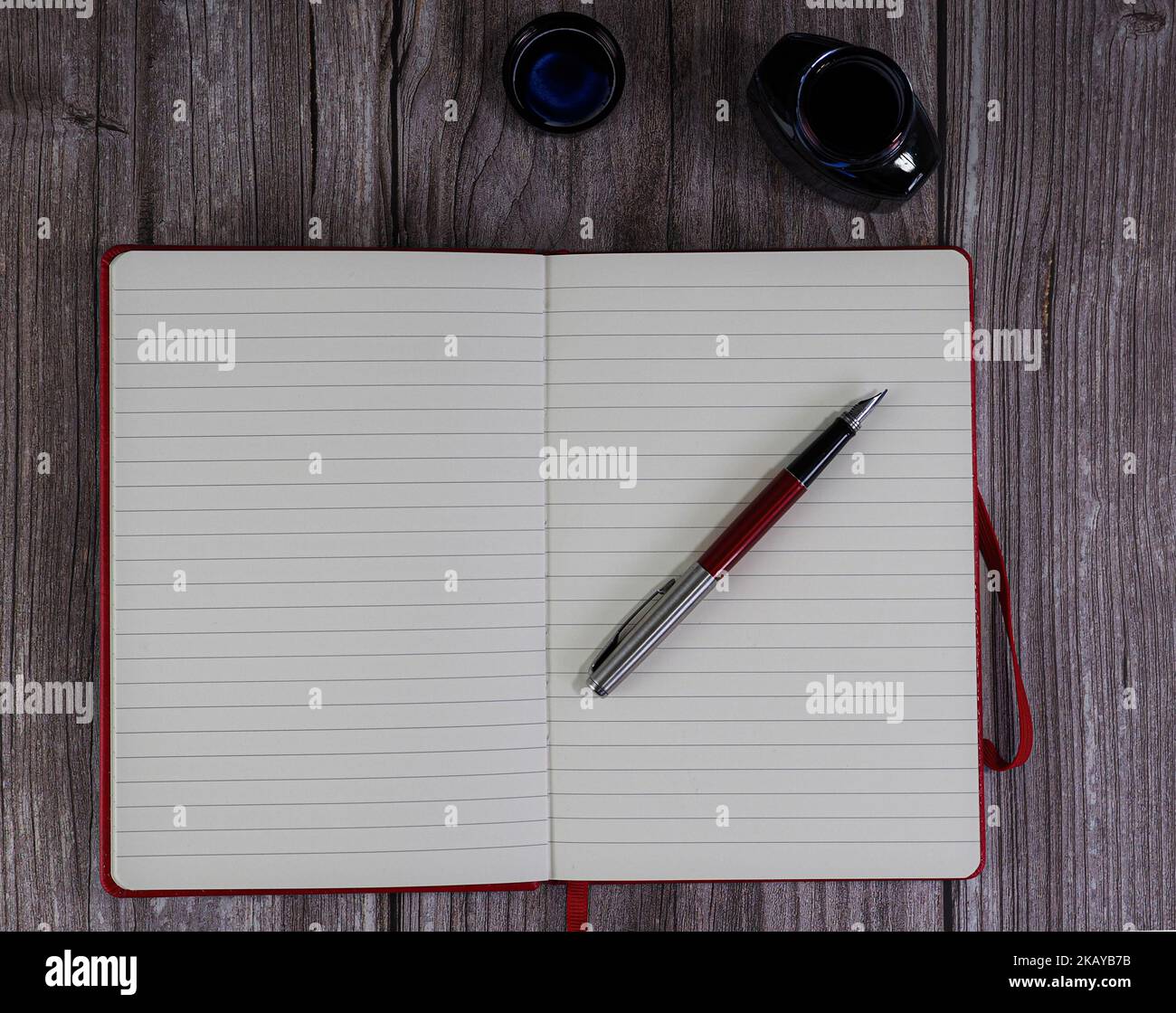 open notebook with pen and inkwell for writing. on wooden background ...