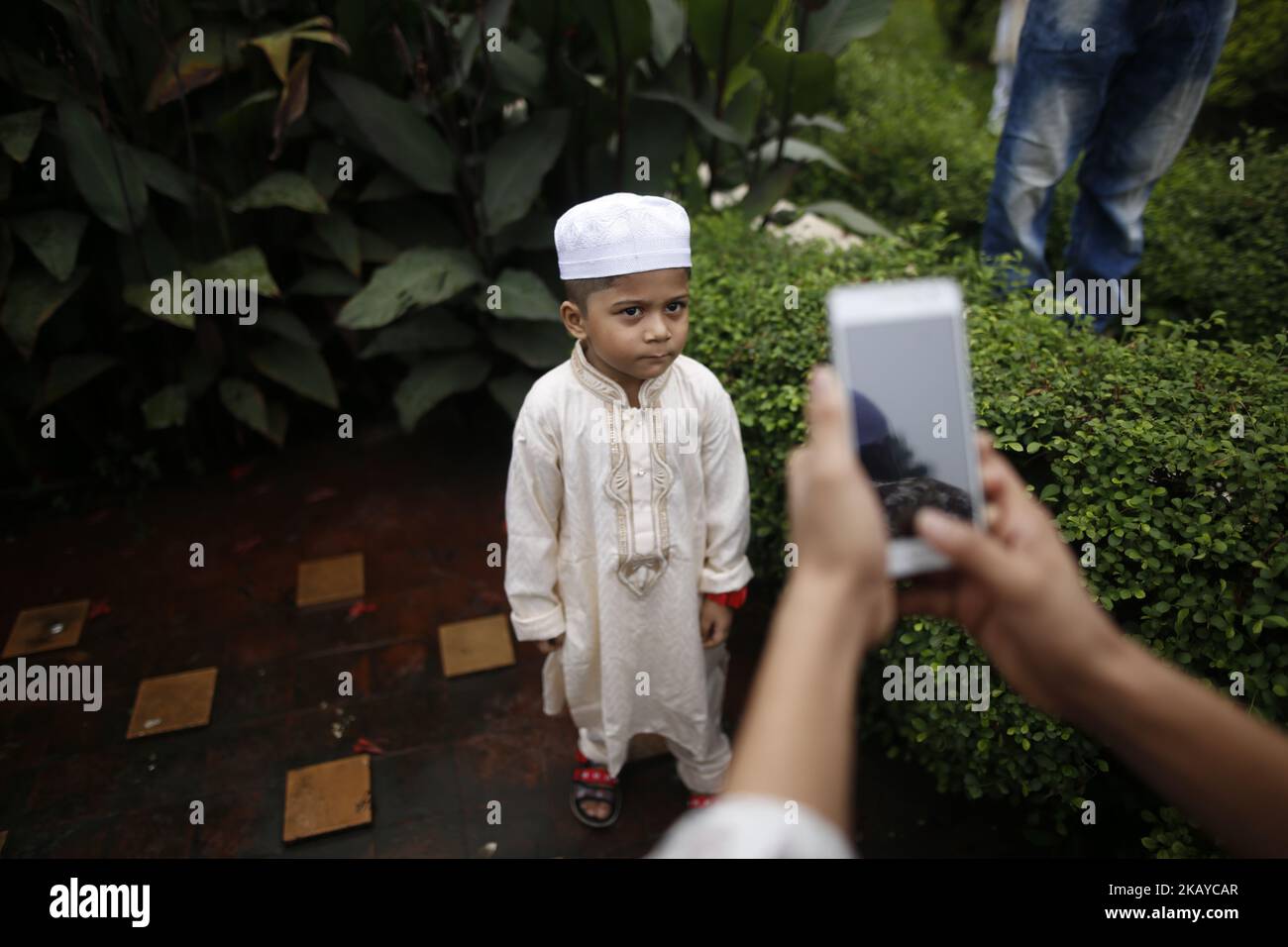 Dhaka, Bangladesh. A Bangladeshi child is taken by a photograph as the ...