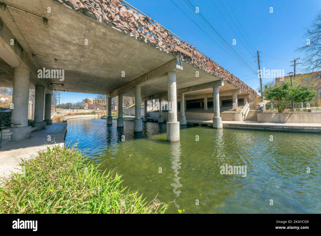 View of a bridge with metal barriers and concrete pillars over the ...