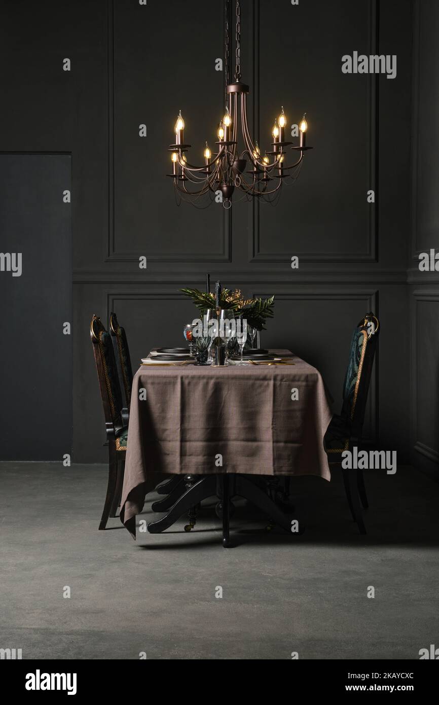 Low key photo of dining table with candlelight Stock Photo - Alamy
