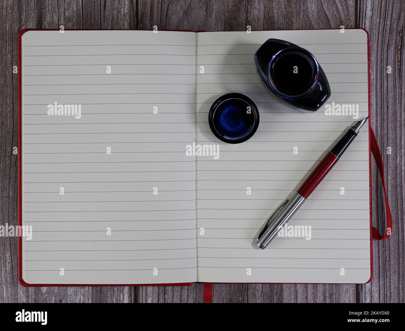 open notebook with pen and inkwell for writing. on wooden background ...
