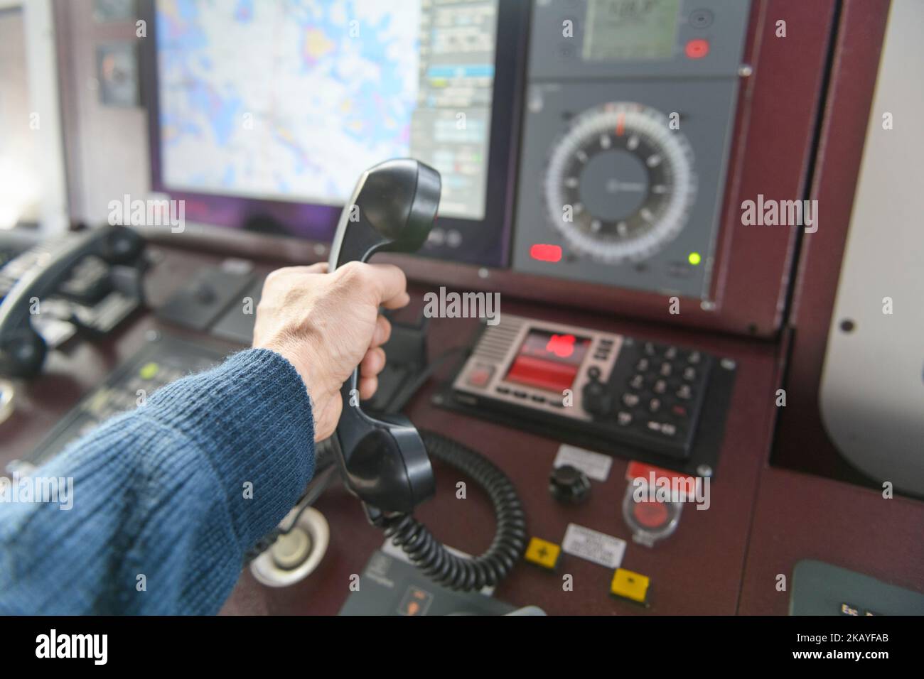 Navigational control panel and VHF radio with hand. Radio communication ...