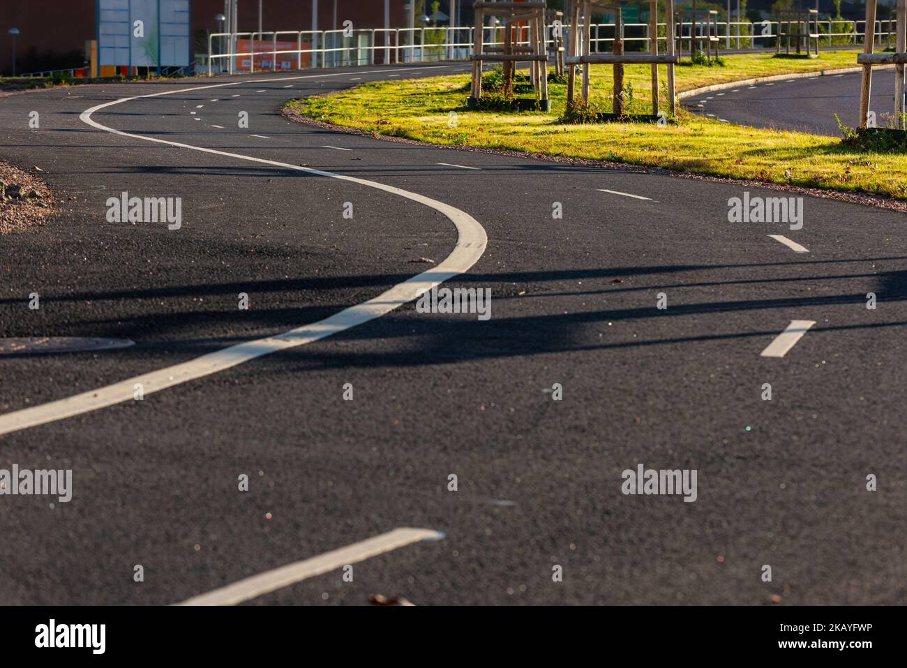 Curvy bike and walking path aling a road Stock Photo - Alamy