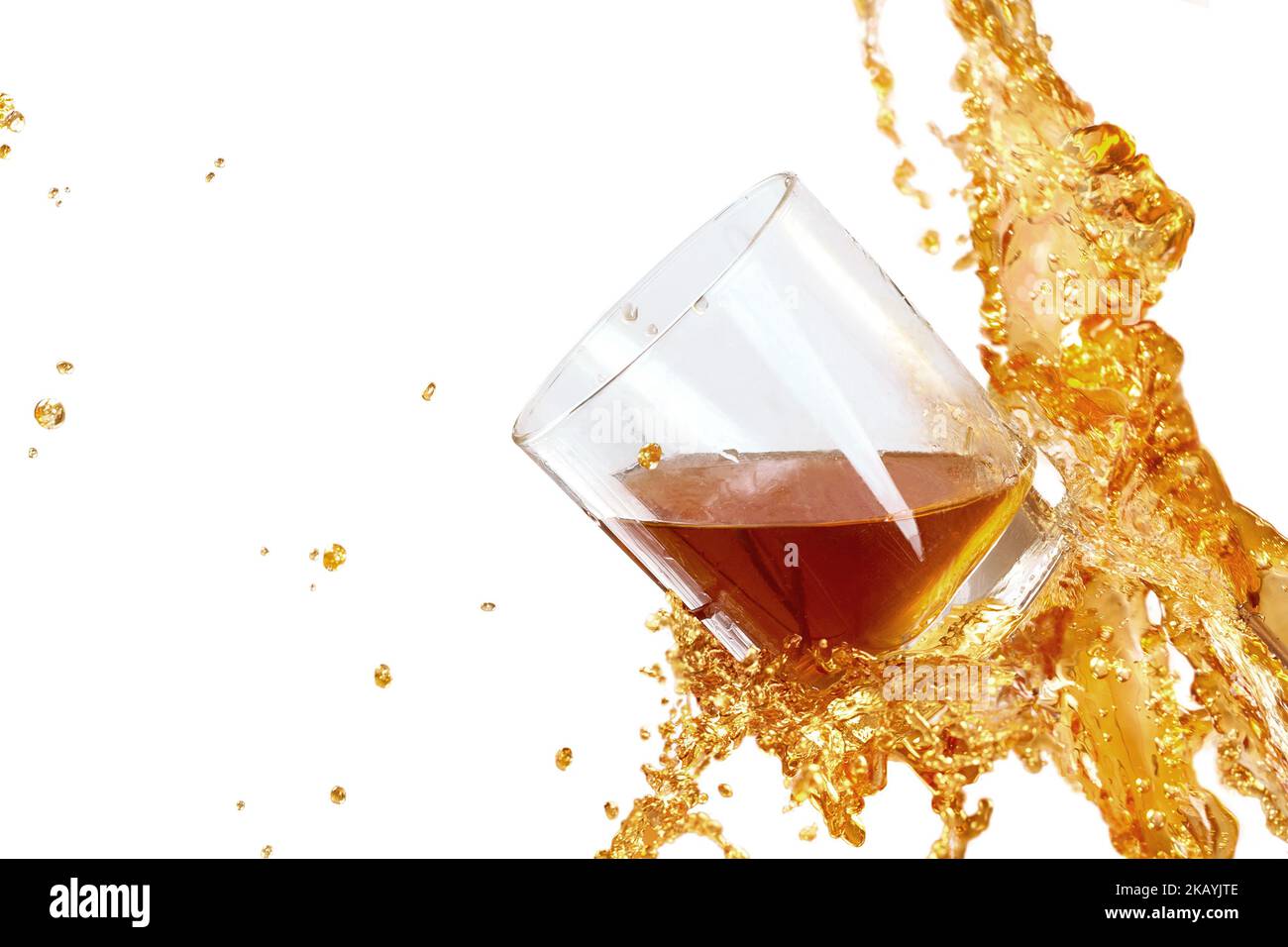 Drink drops around whisky glass on white background Stock Photo - Alamy