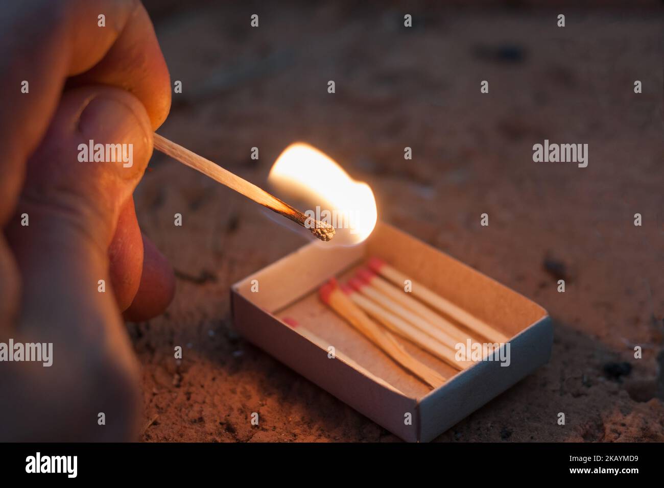 Burning match in the fingers. Close up view Stock Photo - Alamy