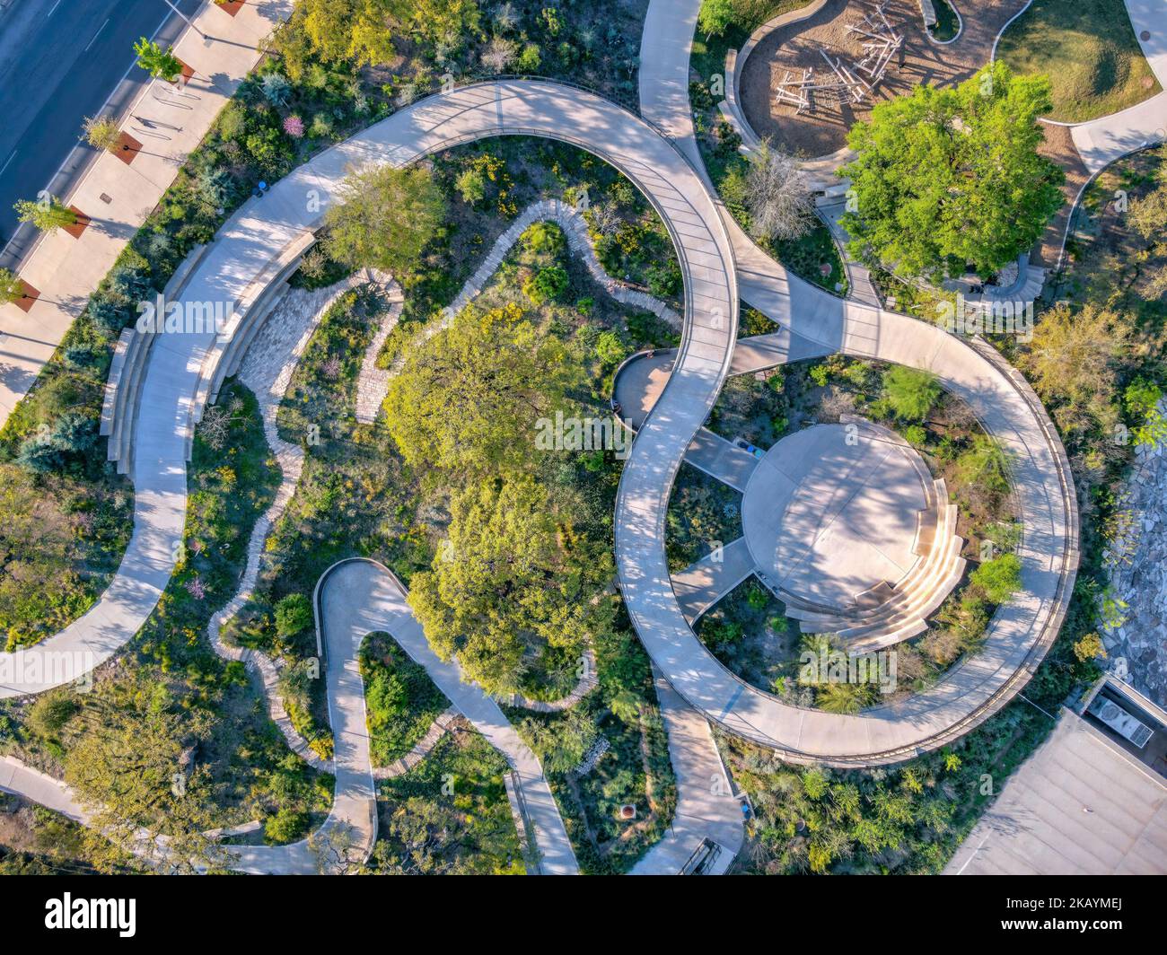 Aerial view of a park with small amphitheater and spiral pathway near ...