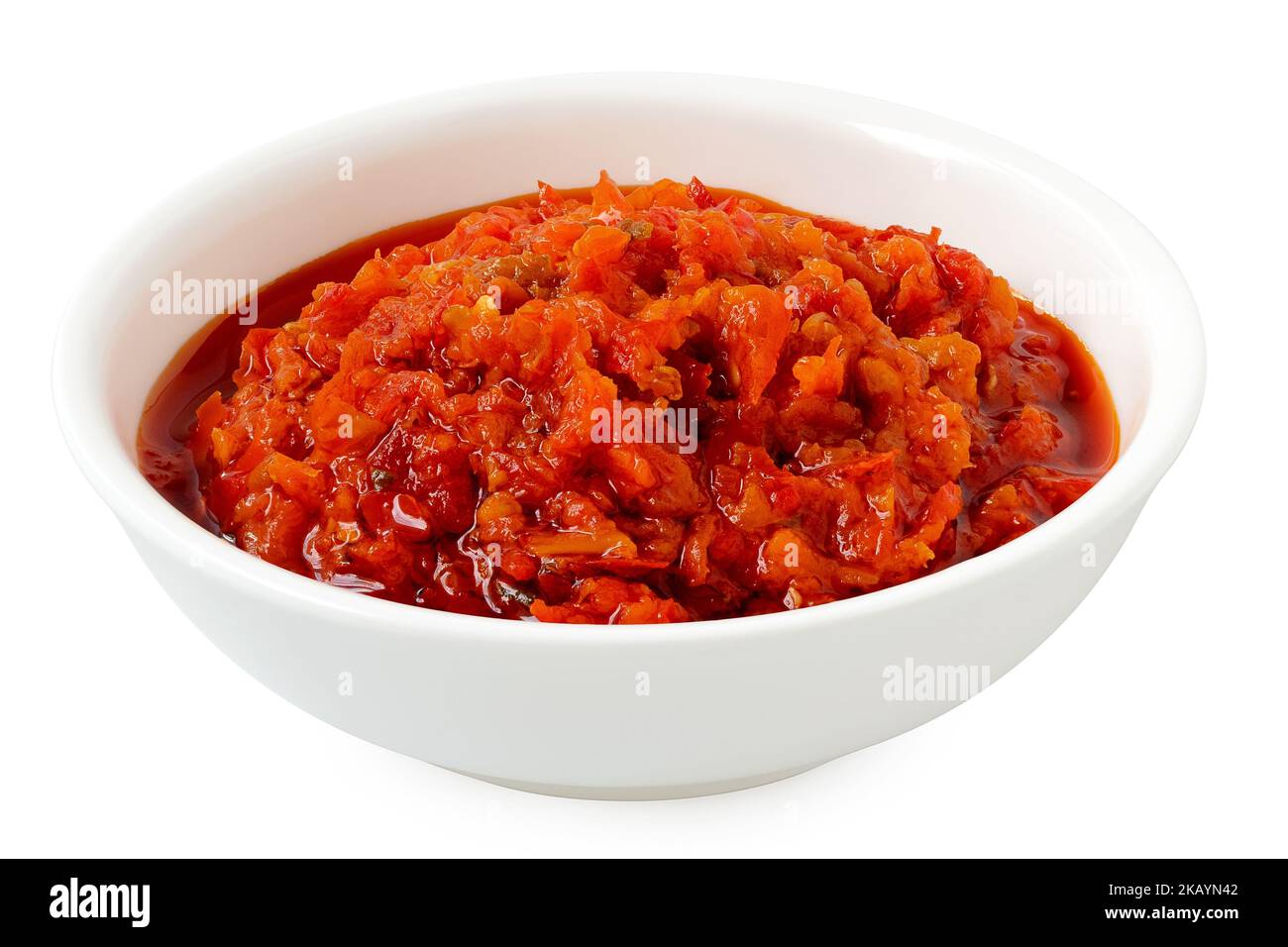 Chopped red chilli peppers in olive oil in white ceramic bowl isolated ...