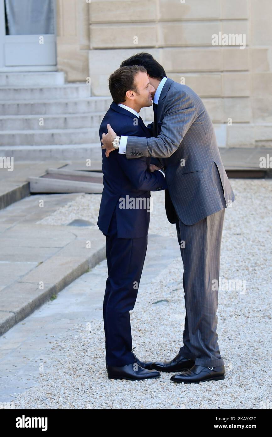 French President Emmanuel Macron (L) welcomes Emir of Qatar Sheikh ...