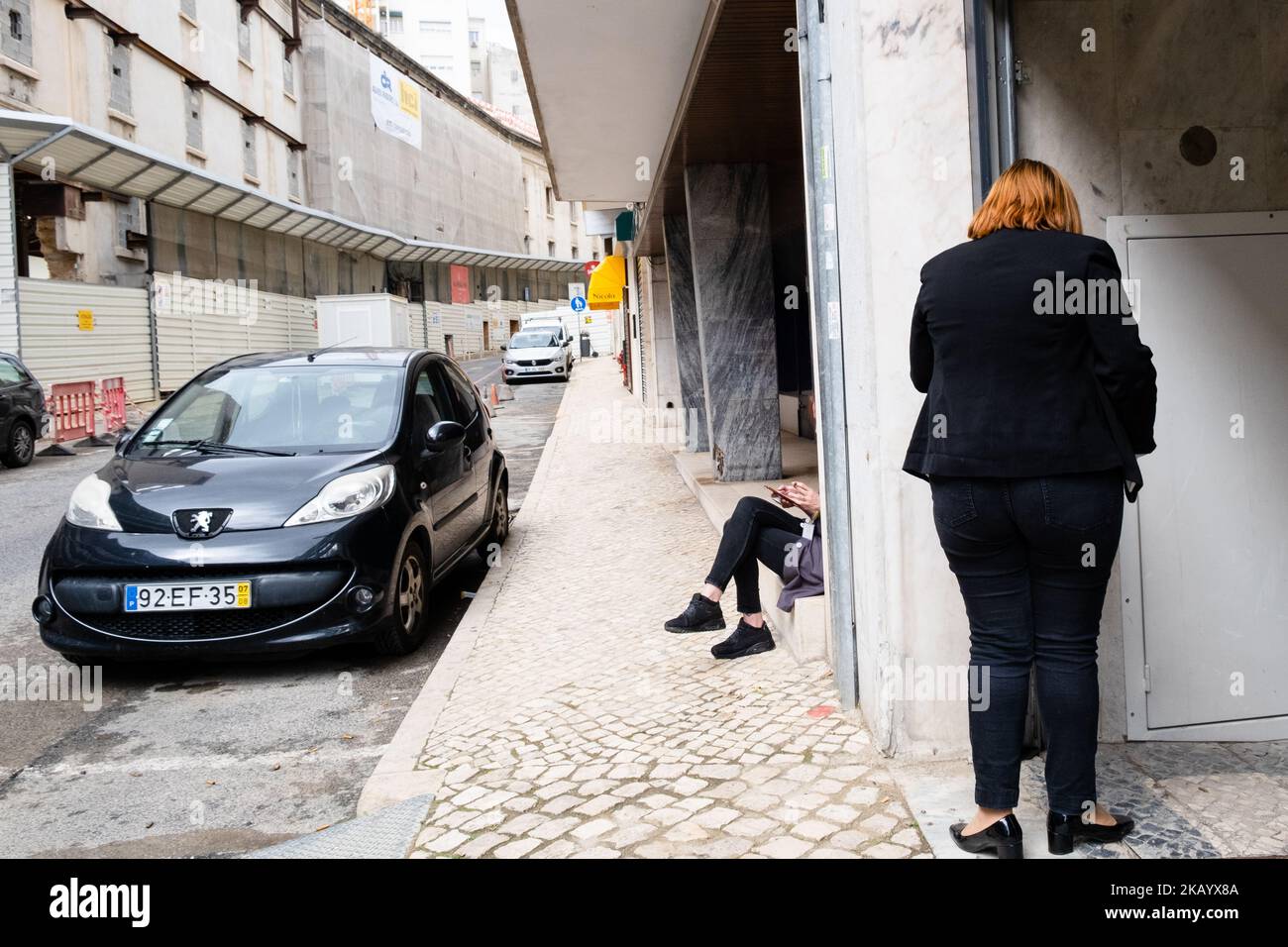 WORKERS ON BREAK: Workers smoking and checking their phones on a break ...