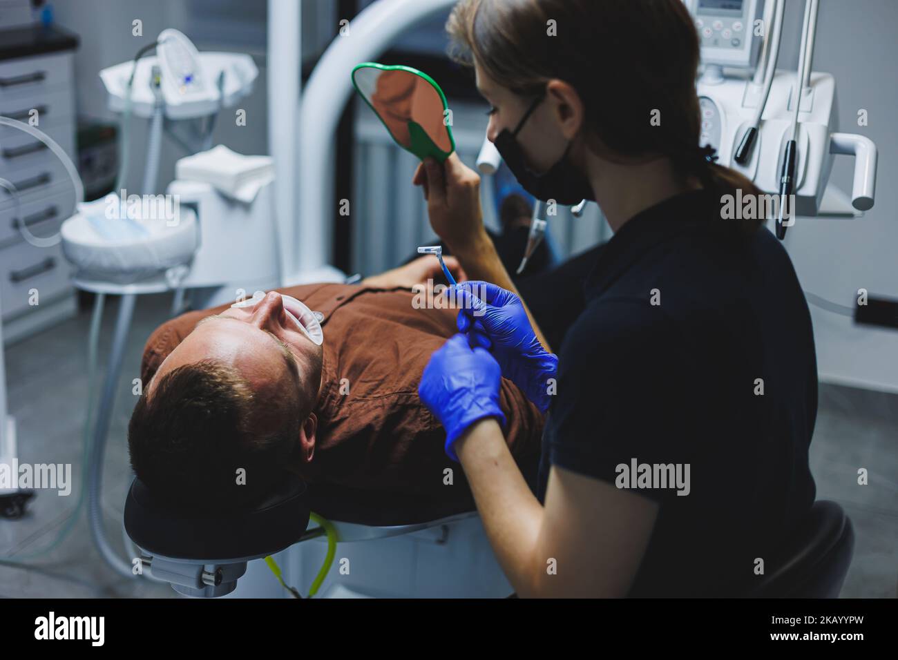 Orthodontic treatment of teeth. The doctor installs metal braces on the ...