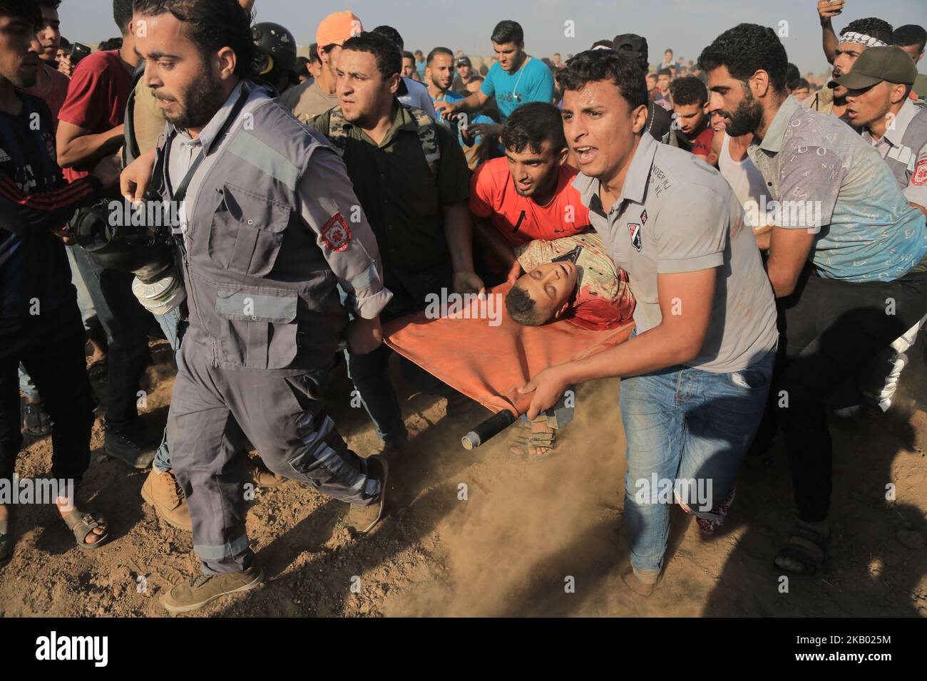 Paramedics and protesters carry the body of 15-year-old killed ...