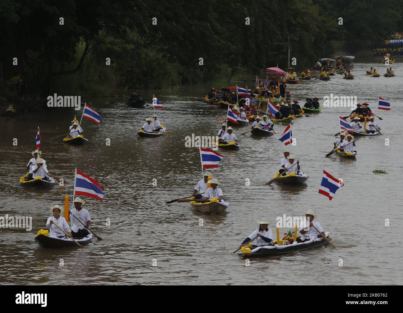 Boats carrying wax castles moves along Noi River take part in a ...