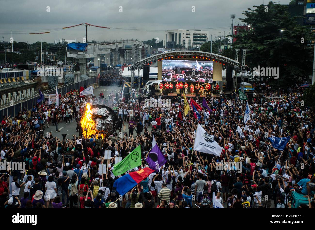 Activists burn an effigy of President Rodrigo Duterte in Batasan ...